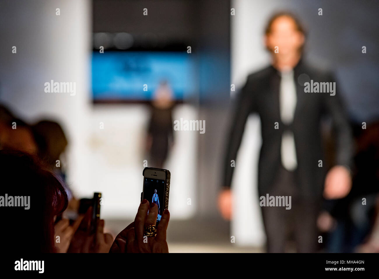 people from audience filming the fashion show with mobile phone Stock ...