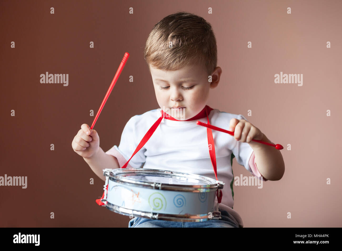 Little boy playing the drum. Lovely baby boy. Child development concept ...