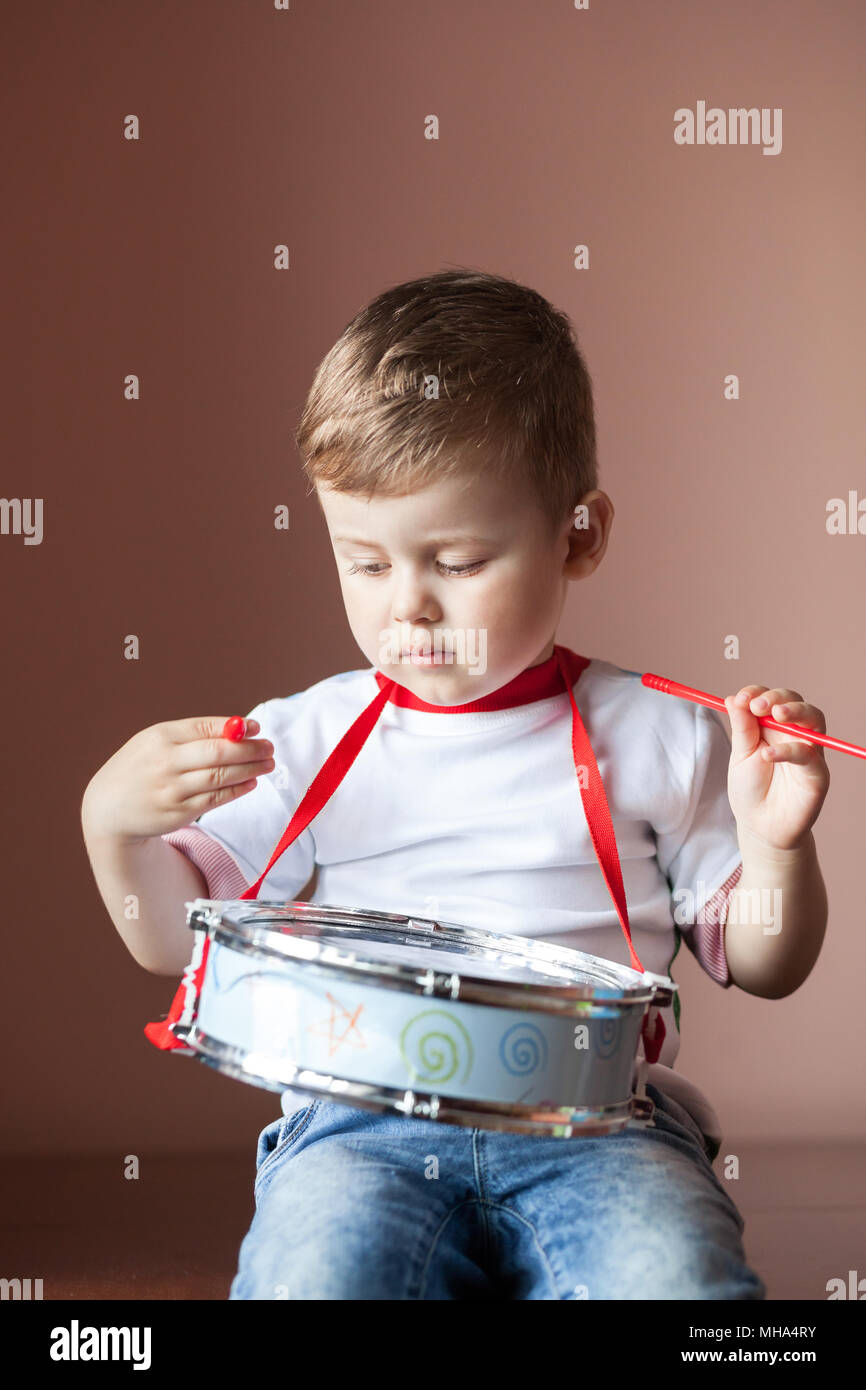 Little boy playing the drum. Lovely baby boy. Child development concept ...