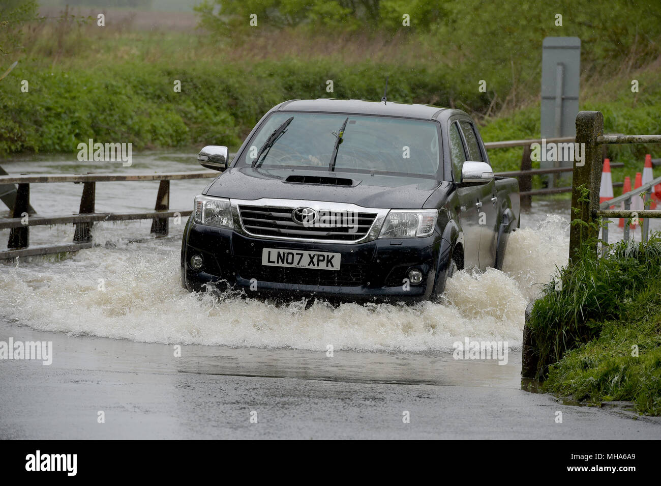 Vehicles drive through a flooded ford in Billericay Essex Stock Photo ...