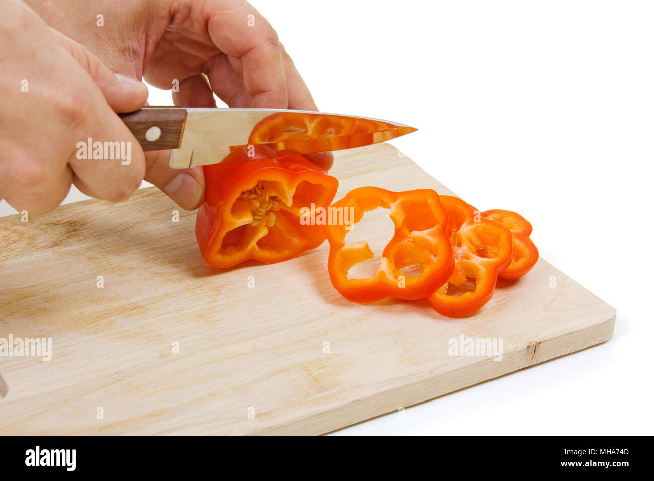 Cutting pepper on the board isolated on white background Stock Photo ...
