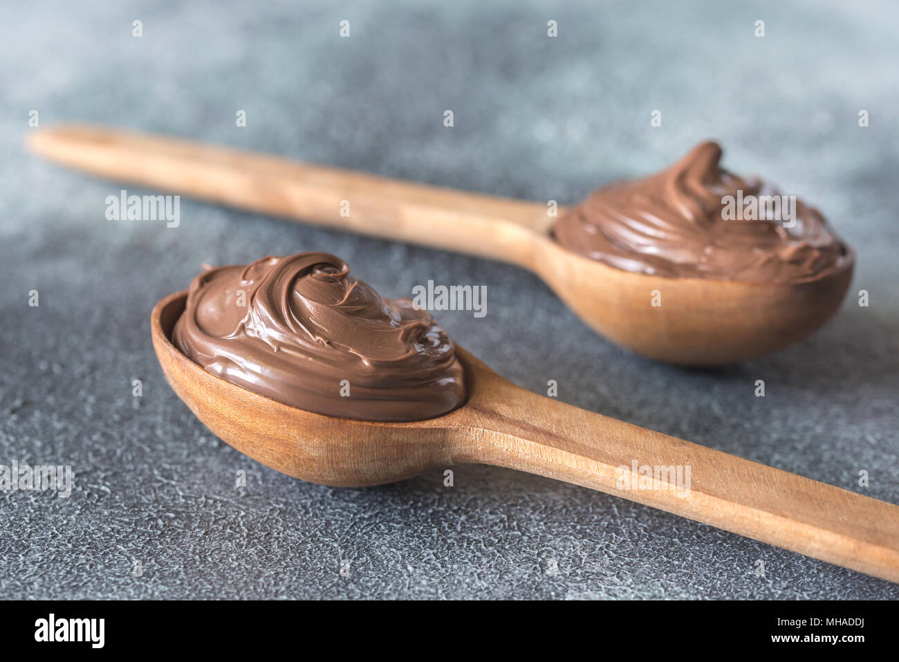 Two wooden spoons of chocolate cream Stock Photo - Alamy