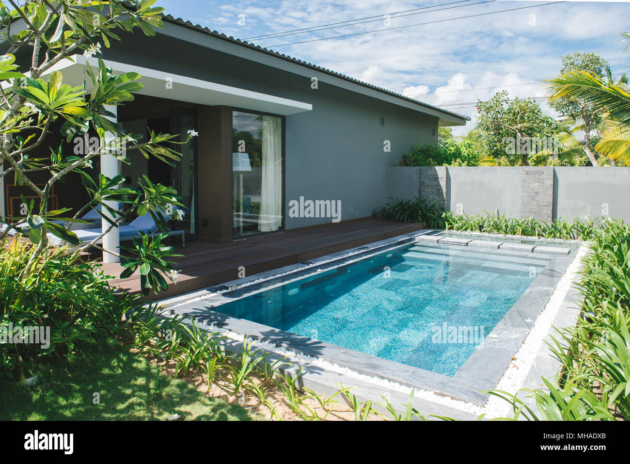 Tropical beach resort. Swimming pool near living room Stock Photo - Alamy
