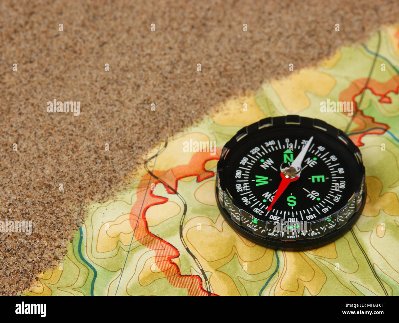 compass on the map with sand Stock Photo - Alamy