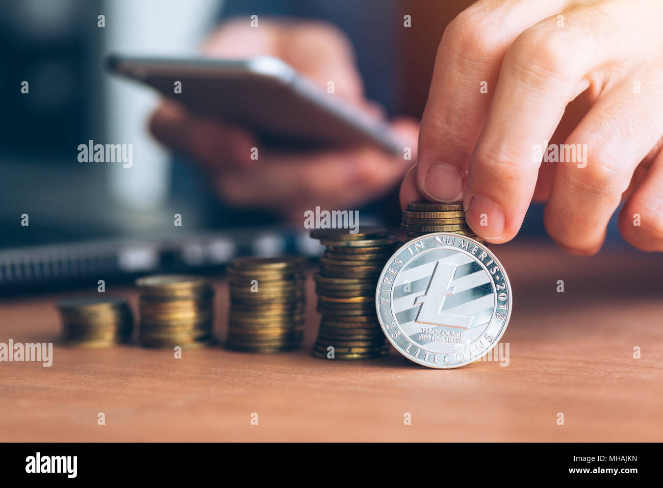 Litecoin cryptocurrency trader, business person using modern technology ...