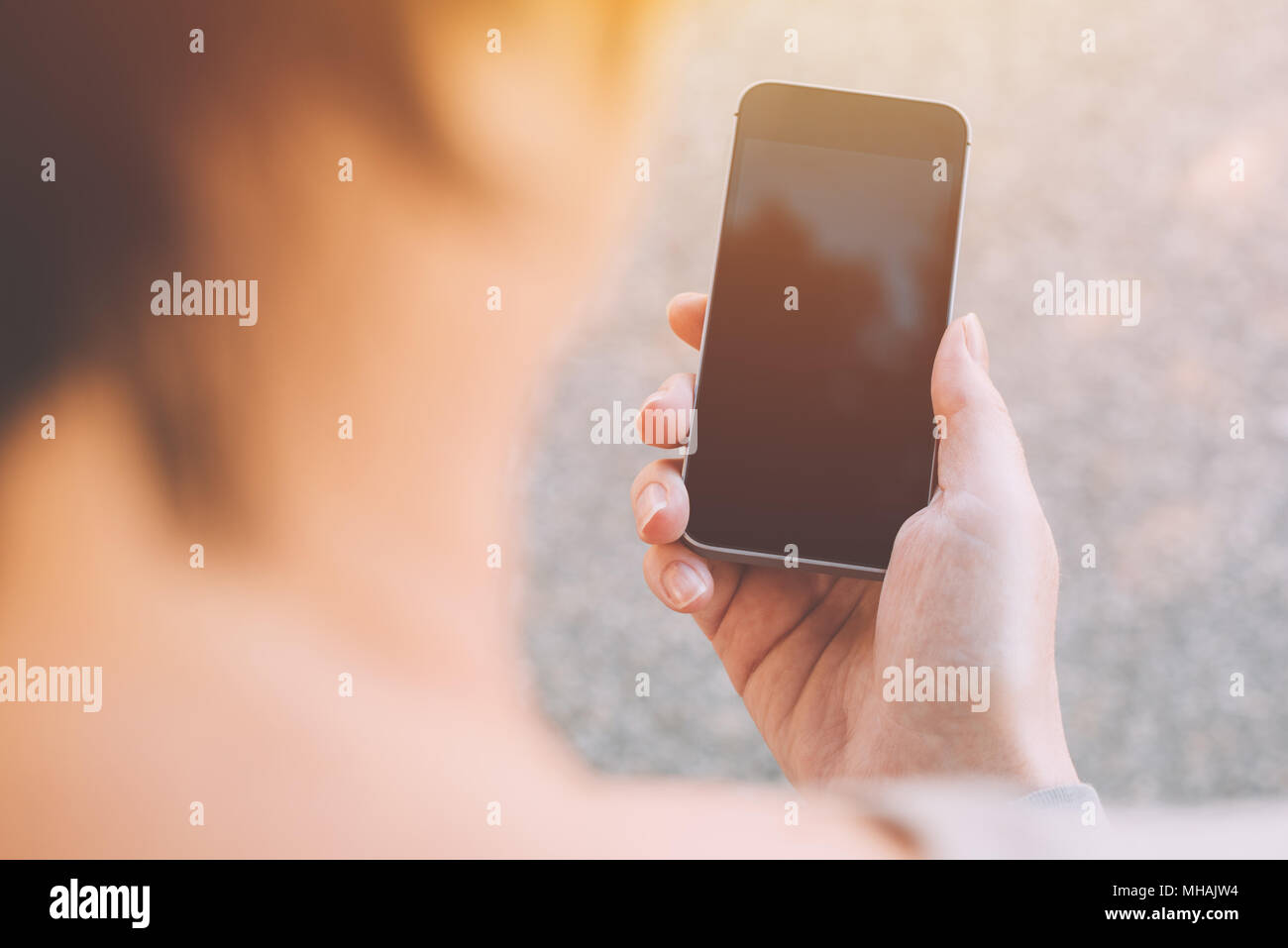 Close up of female hands using smartphone outdoors. Woman in sportswear ...