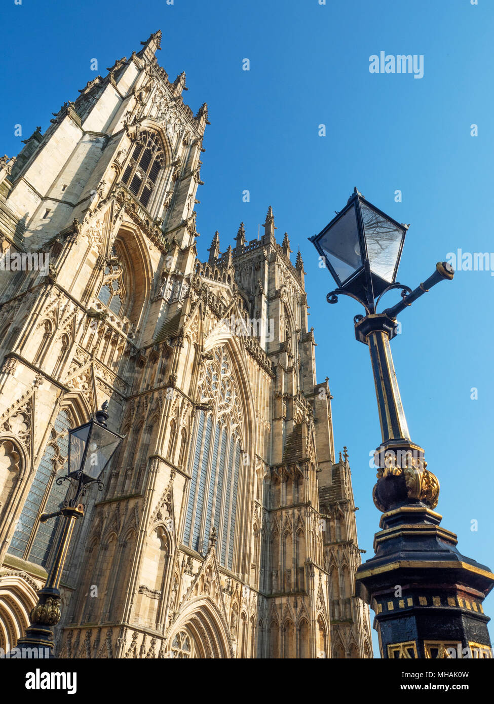 West front of York Minster and old lamp standard illuminated by spring ...