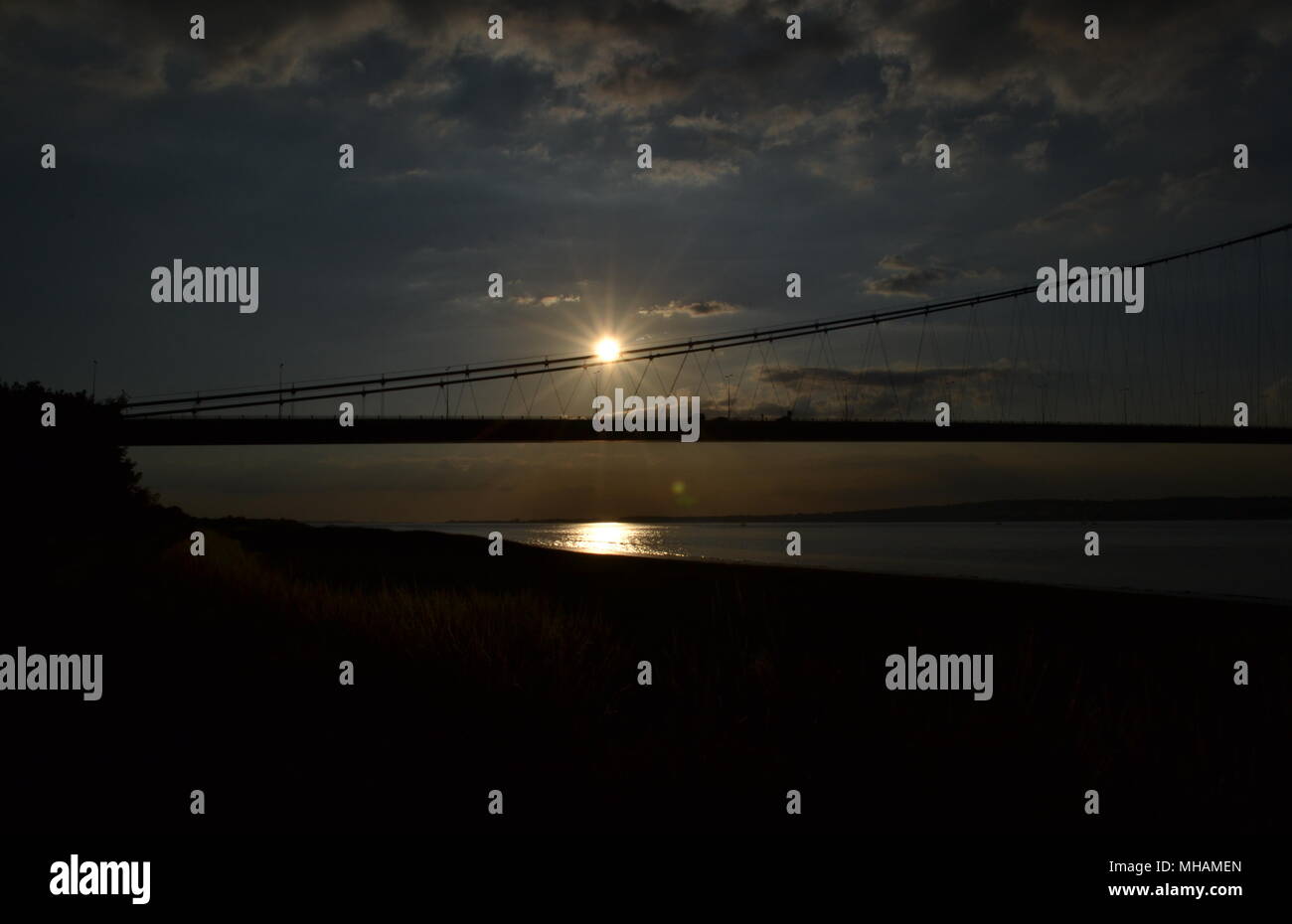 An image showing the humber bridge with the sun dawning in the distance ...