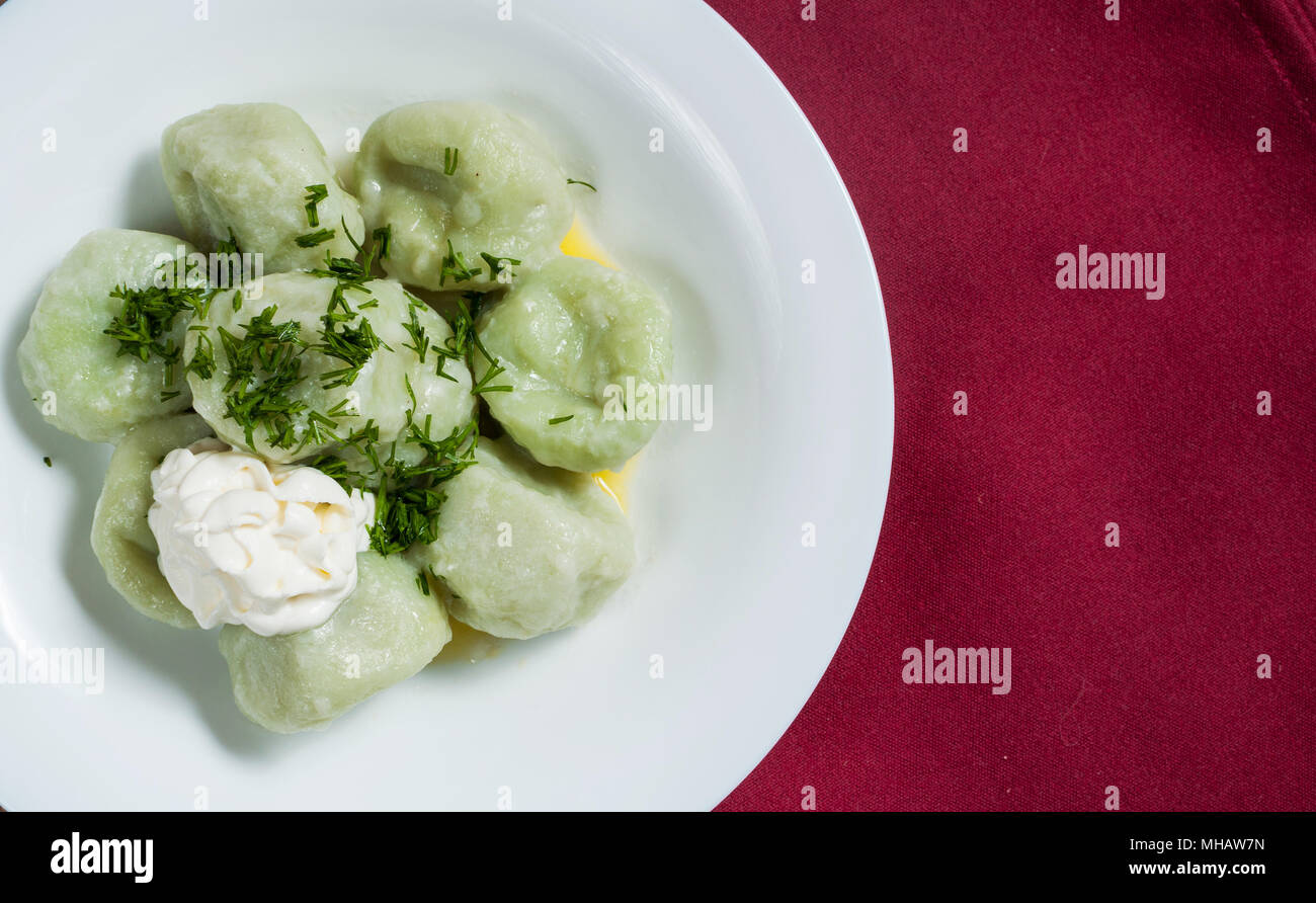 Boiled meat dumplings served with sour cream and dill. Traditional ...