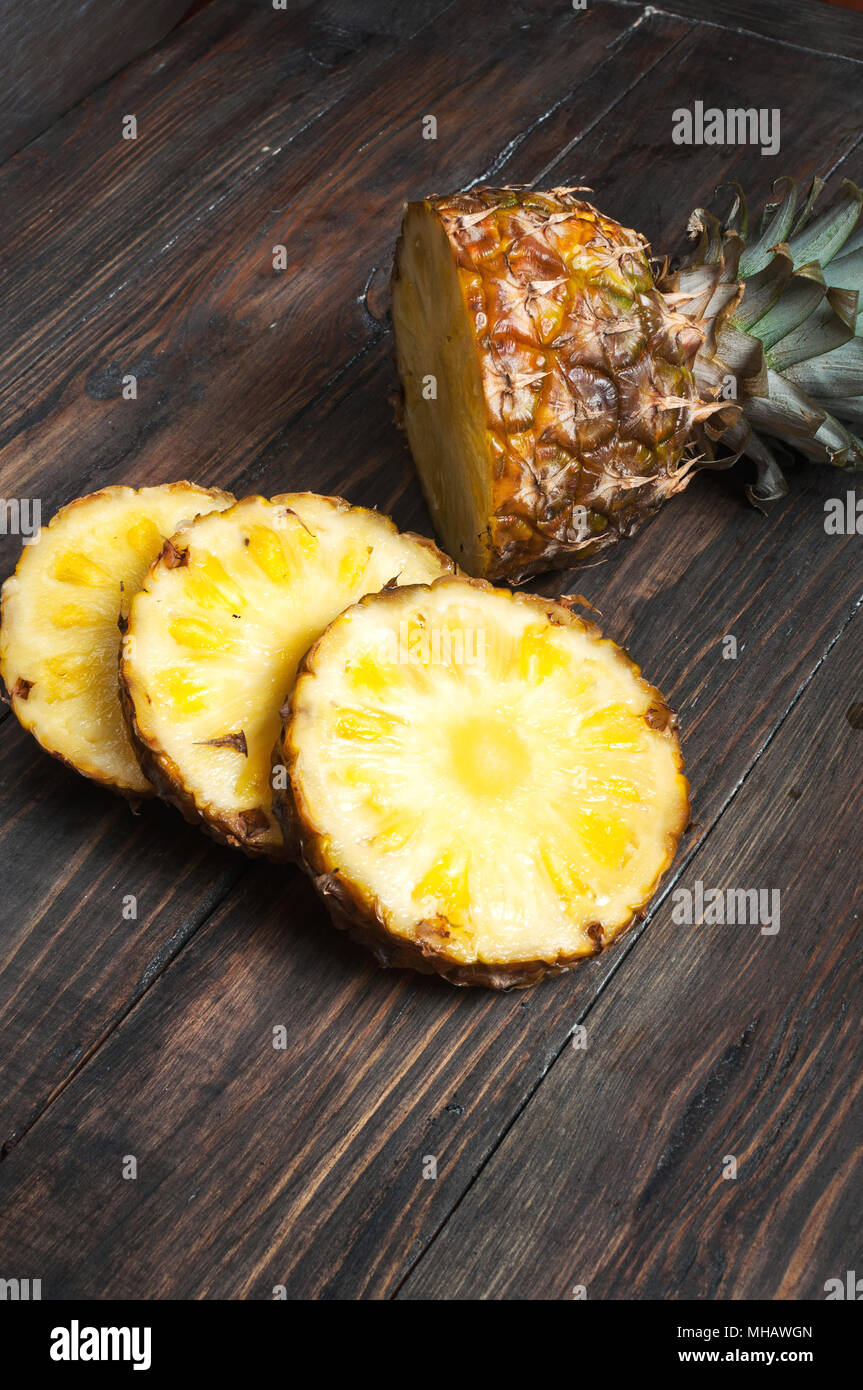 Fresh sliced pineapple on a stone stand. On the stone table. Top view ...