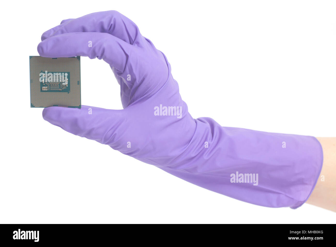 Hand wearing gloves holding a CPU computer processor microchip isolated ...