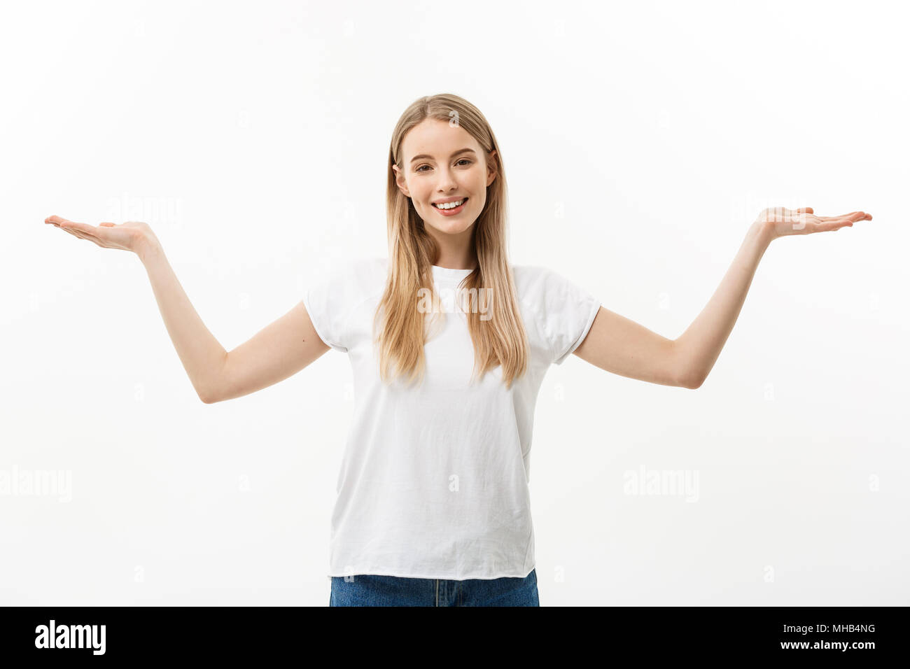 Portrait of young caucasian woman smiling and presenting two hands on ...