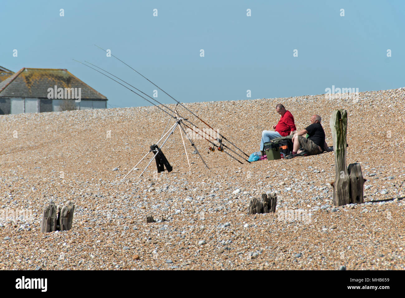 Sea-angling from the beach at Normans Bay, Sussex, UKmen fishing on ...