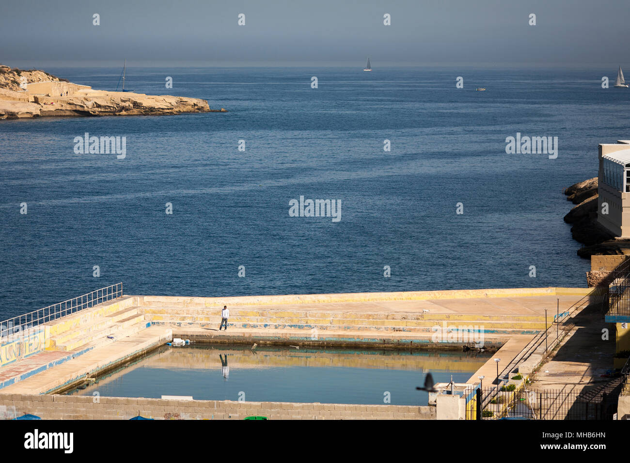 Looking down from the heavily fortified walls of Valletta across a salt ...