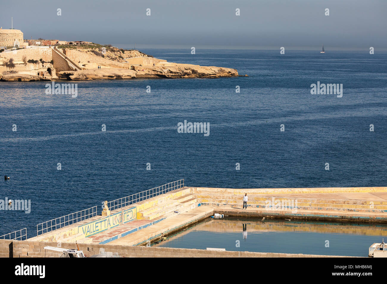 Looking down from the heavily fortified walls of Valletta across a salt ...