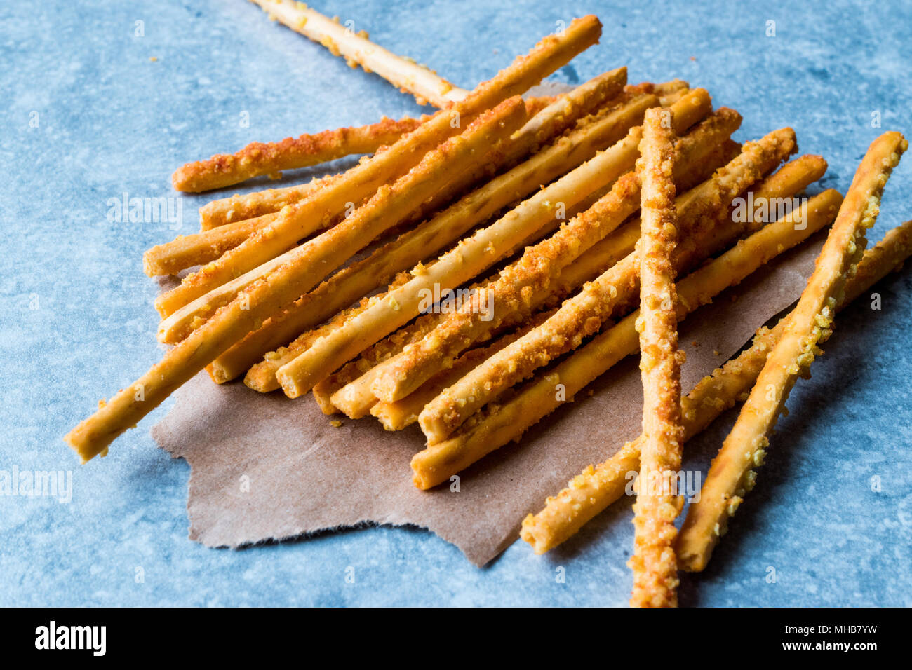 Salty Pretzel Crunchy Sticks on Blue Surface. fast Food Stock Photo - Alamy