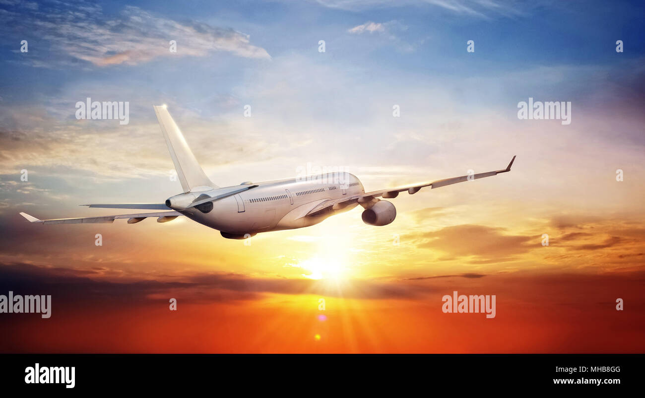 Passengers commercial airplane flying above clouds, side view. Concept ...