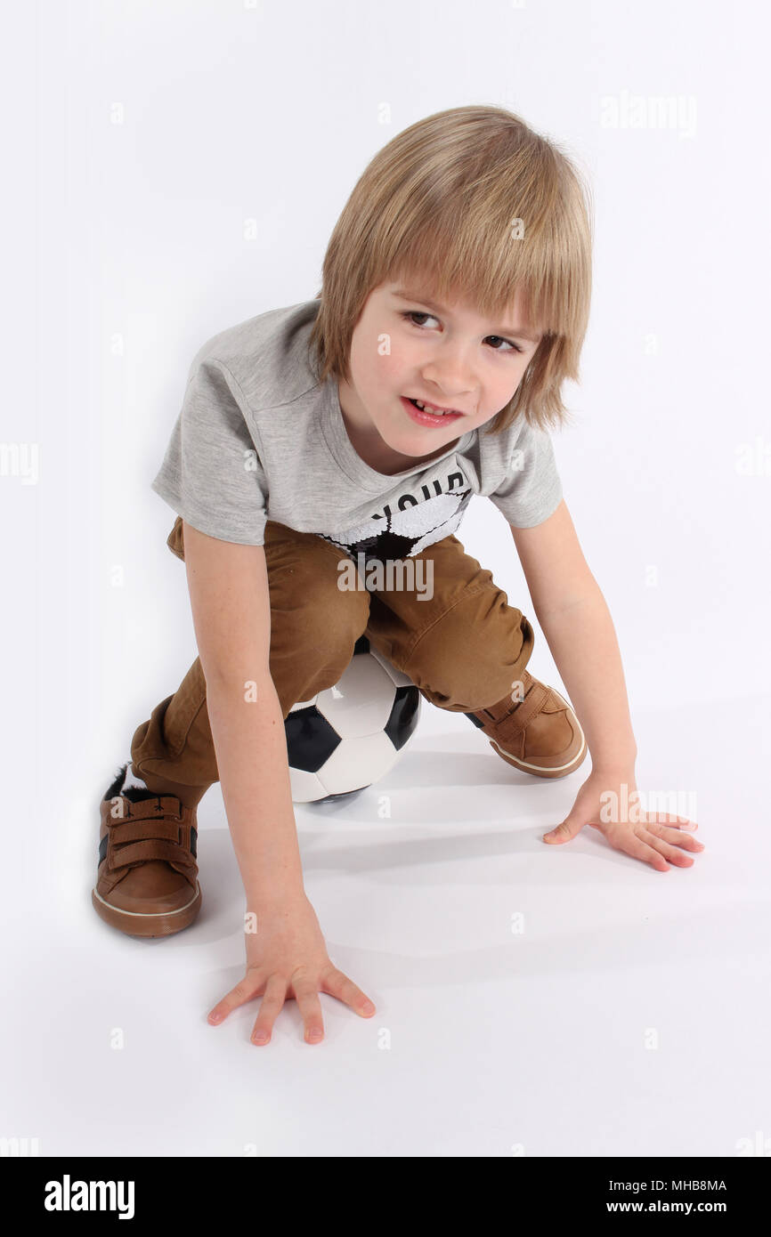 Little boy sitting on a soccer ball Stock Photo - Alamy