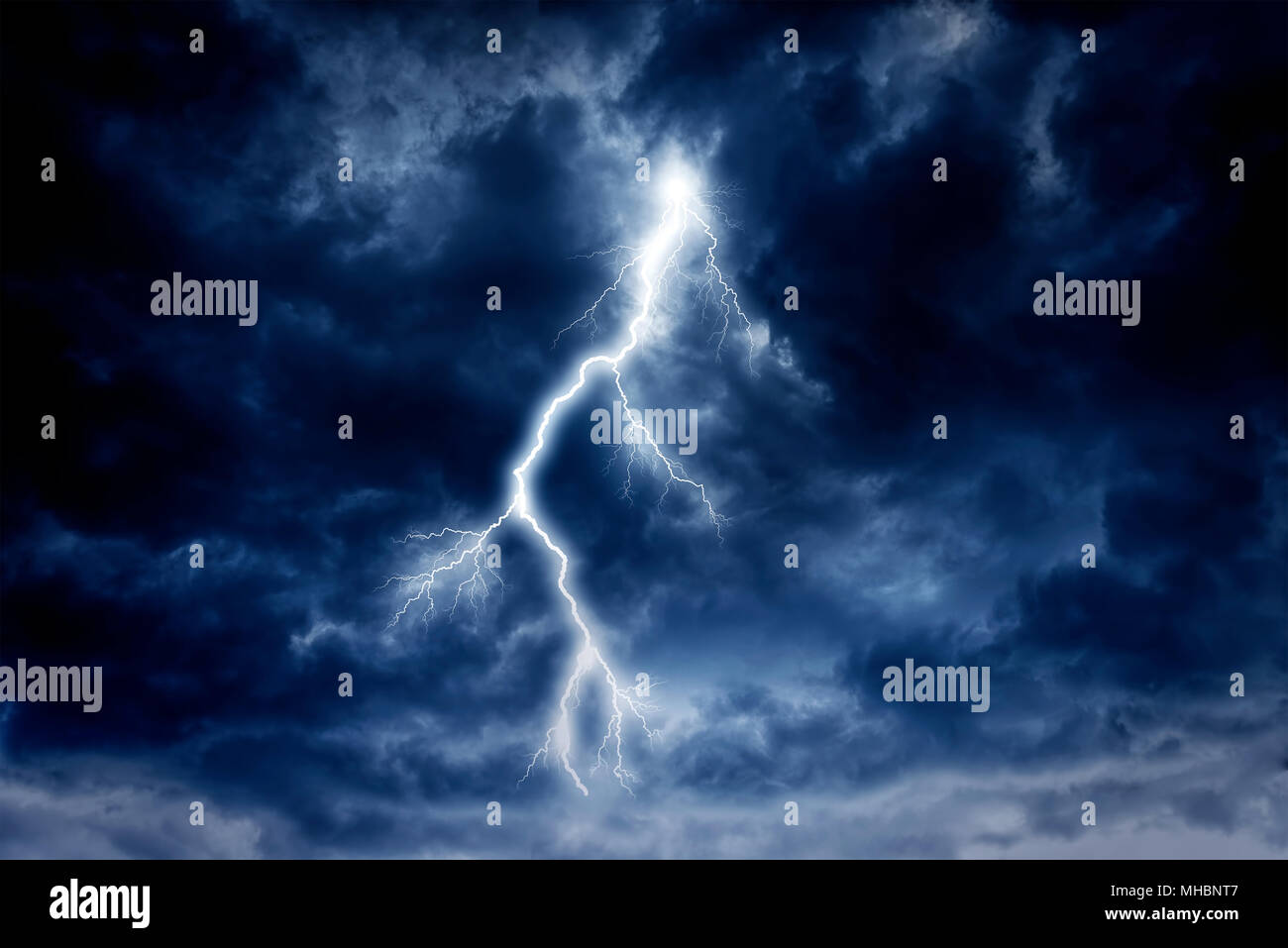 A lightning strike on a cloudy dramatic stormy sky Stock Photo - Alamy