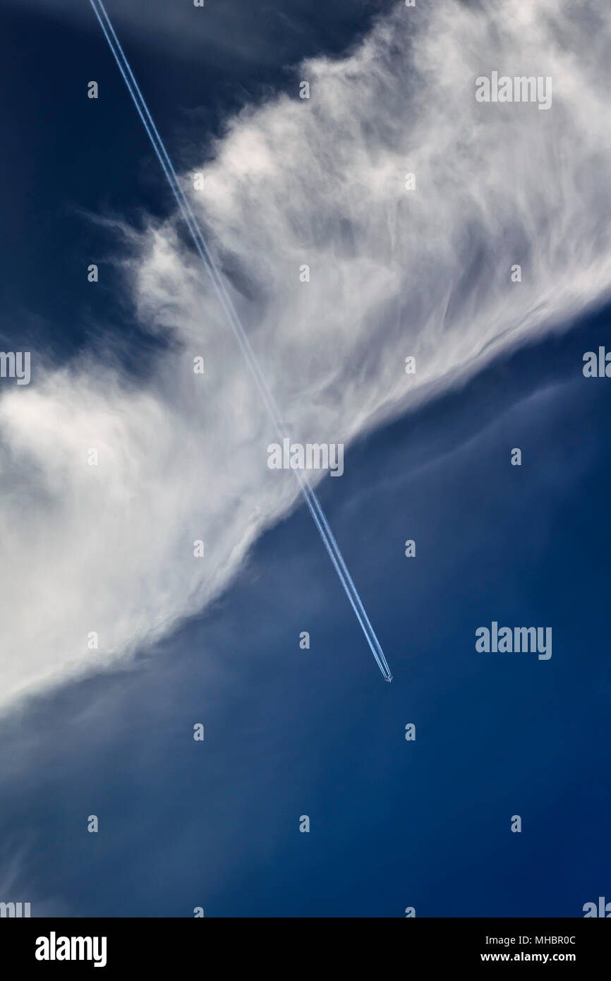 Airplane with condensation trails hi-res stock photography and images ...