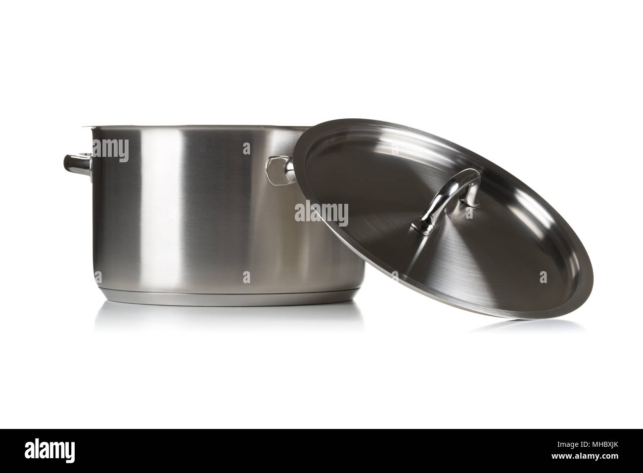 Empty open stainless steel cooking pot with lid over white background ...