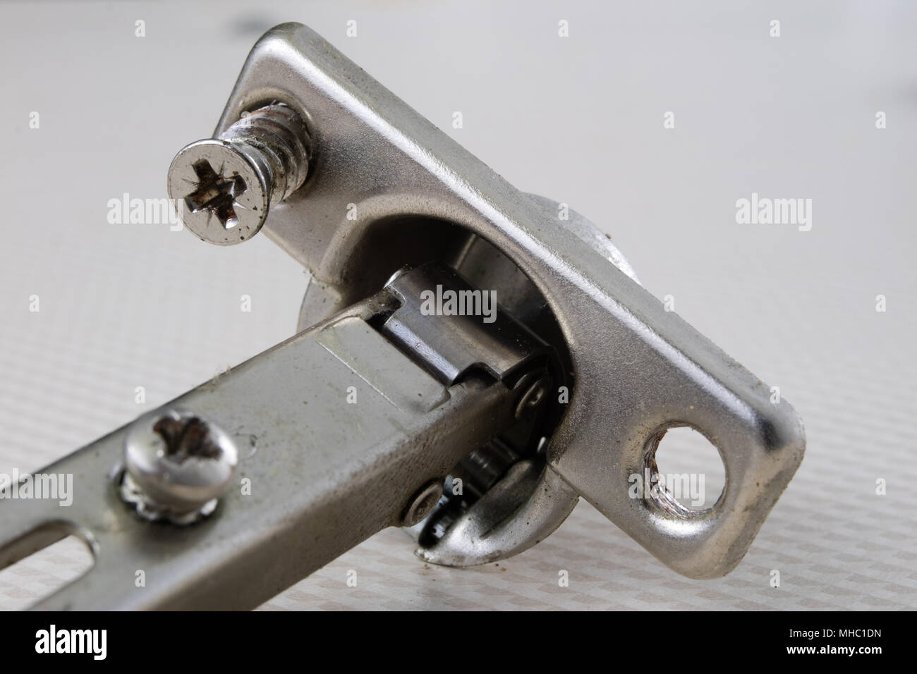 Assembly of hinges in a carpentry workshop. Joinery accessories in a ...