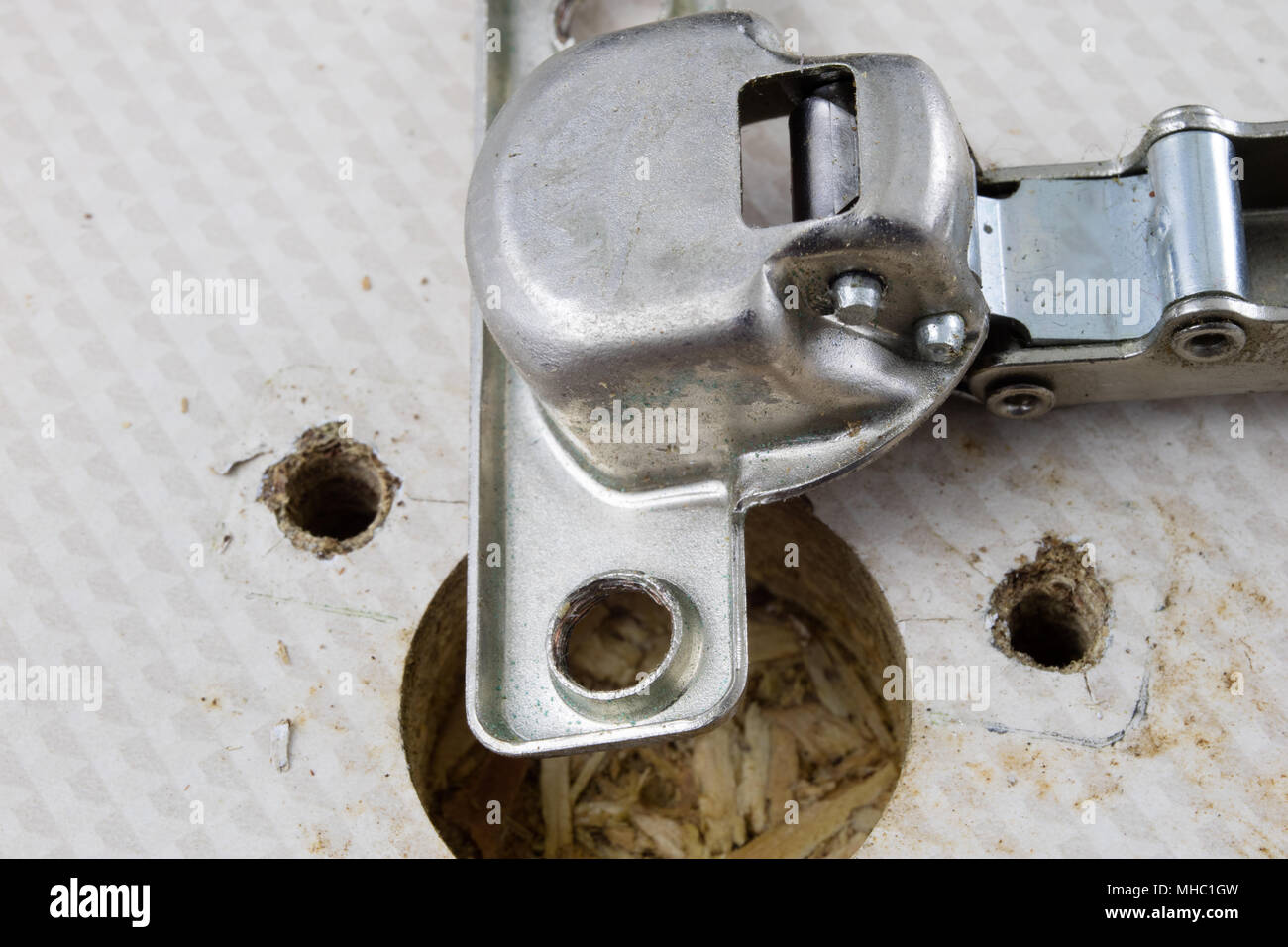 Assembly of hinges in a carpentry workshop. Joinery accessories in a ...