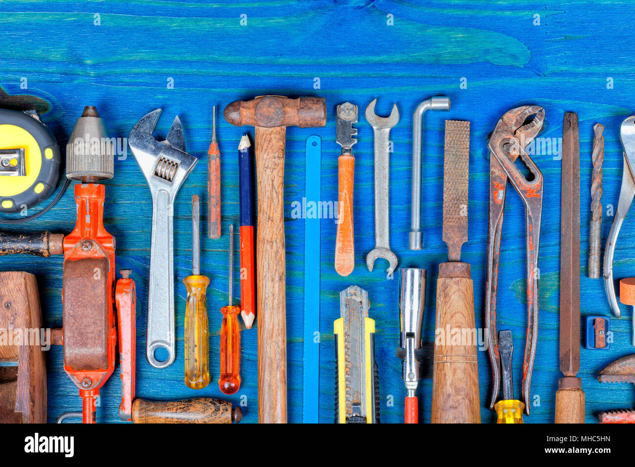 Many manual tools on wood painted blue color background Stock Photo - Alamy