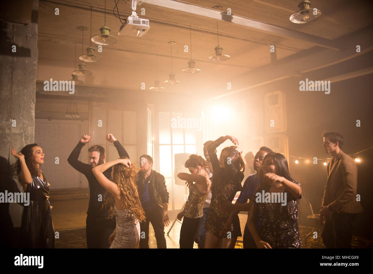 Crowd of trendy young people dancing in nightclub and enjoying party ...