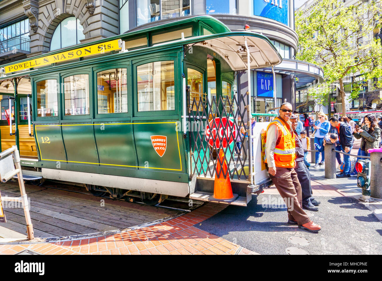 SAN FRANCISCO - APR 2, 2018: Workers rotate a cable car at the Powell ...