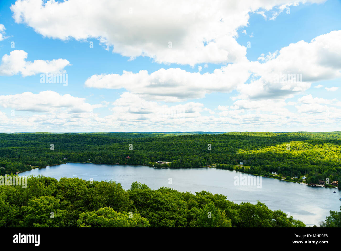 Wide view of cottage country, from a top a lookout tower, brightly ...