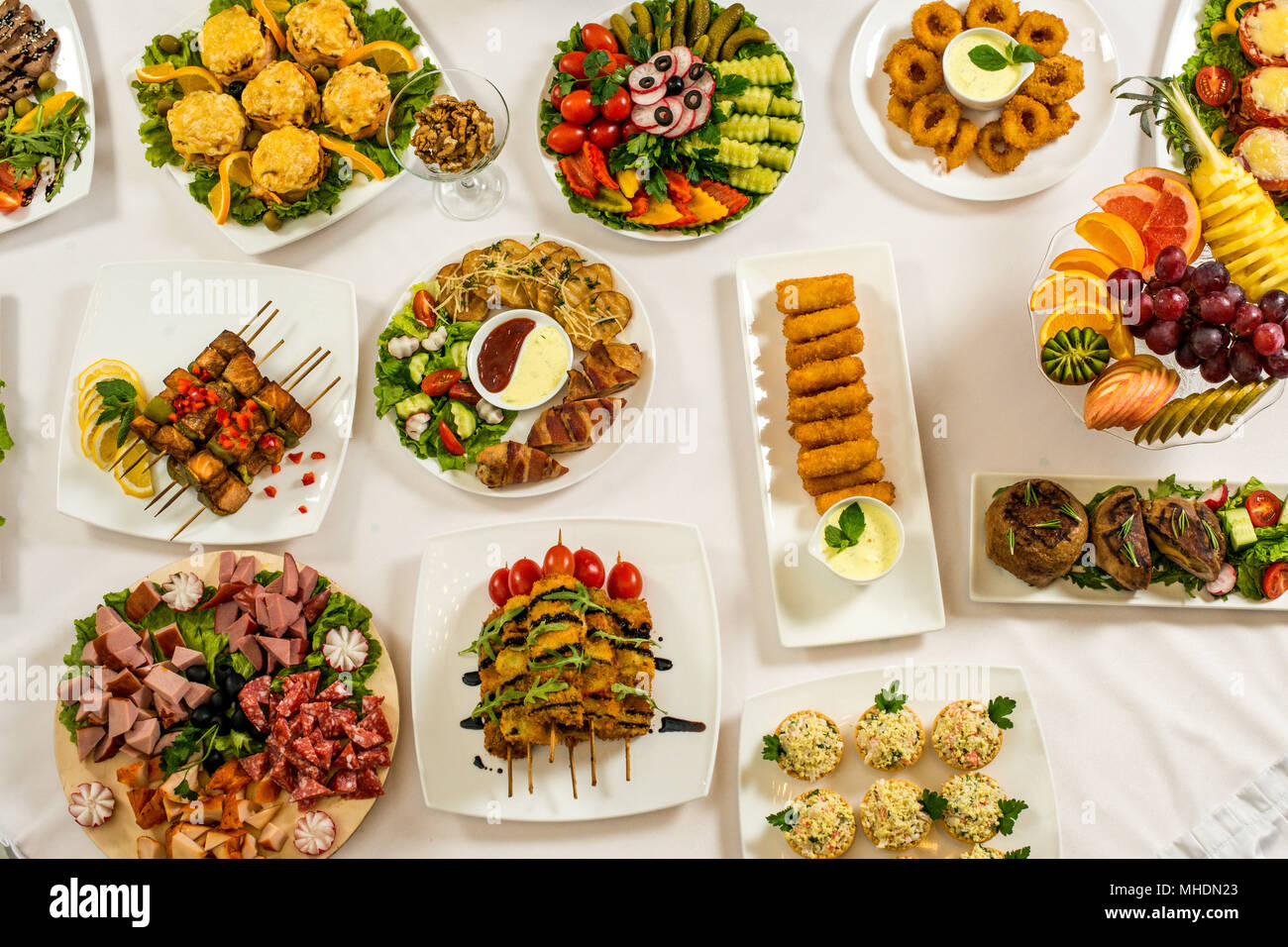 Different snacks for eating on holiday in white plates on white ...