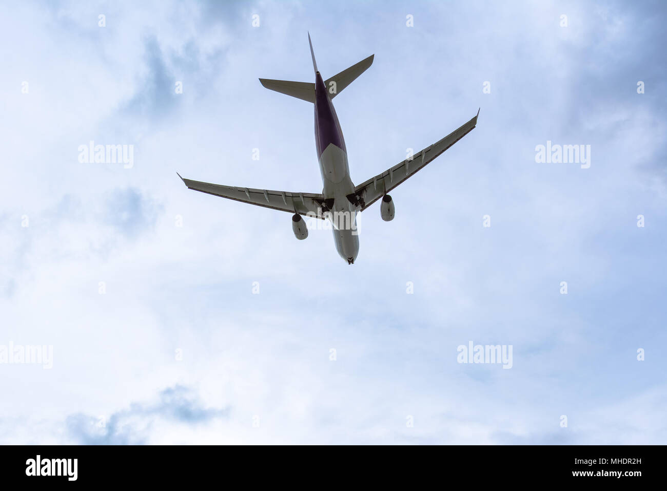 Under view of Airplane in the cloudy sky for background Stock Photo - Alamy