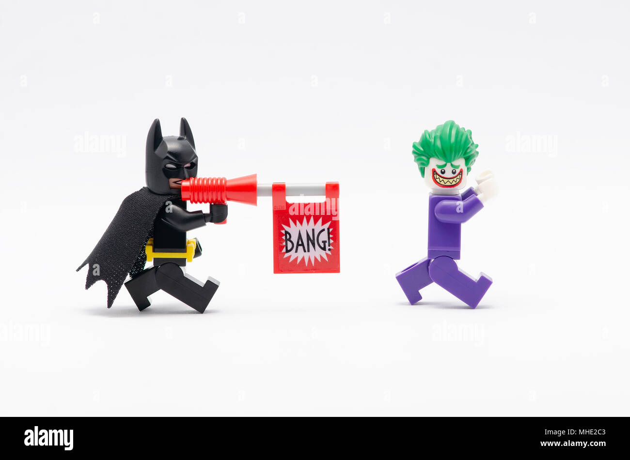 mini figure of batman with bang gun chasing joker. Lego minifigures are ...