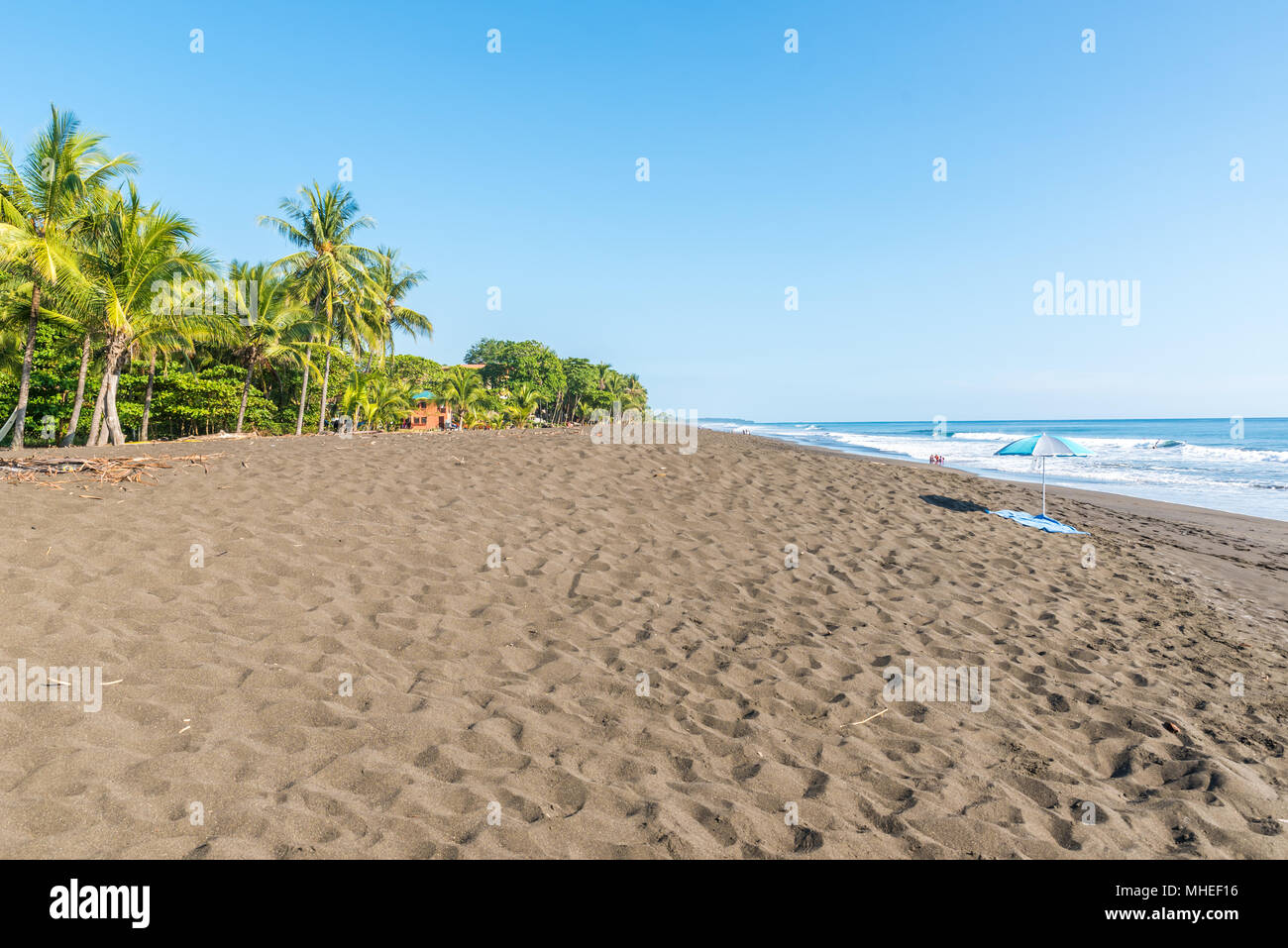 Beach umbrella and towel at playa hermosa en Costa Rica - pacific coast ...