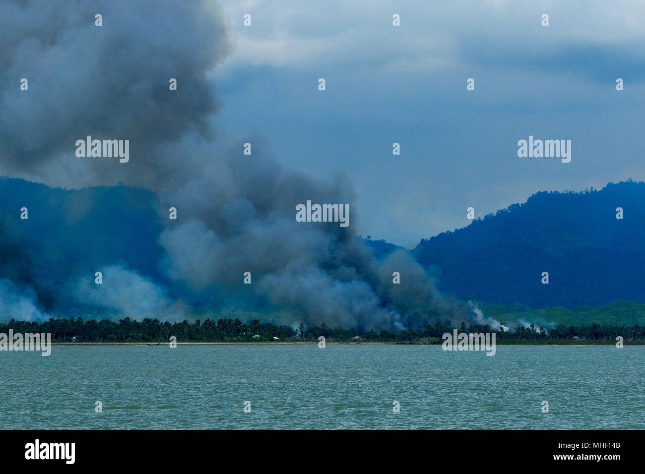 Smoke is seen on the villages in Maungdaw area in Myanmar border set on ...