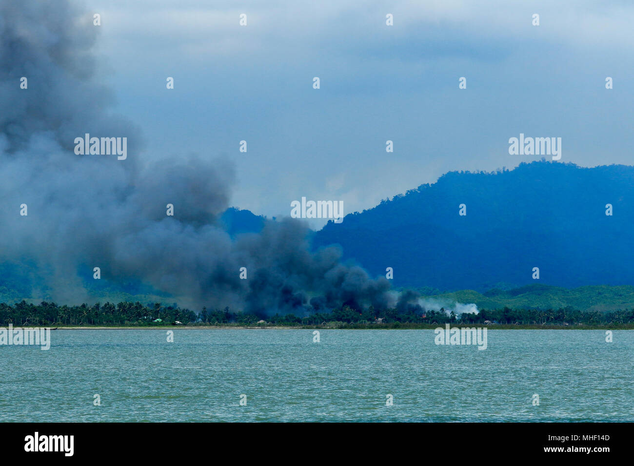 Smoke is seen on the villages in Maungdaw area in Myanmar border set on ...