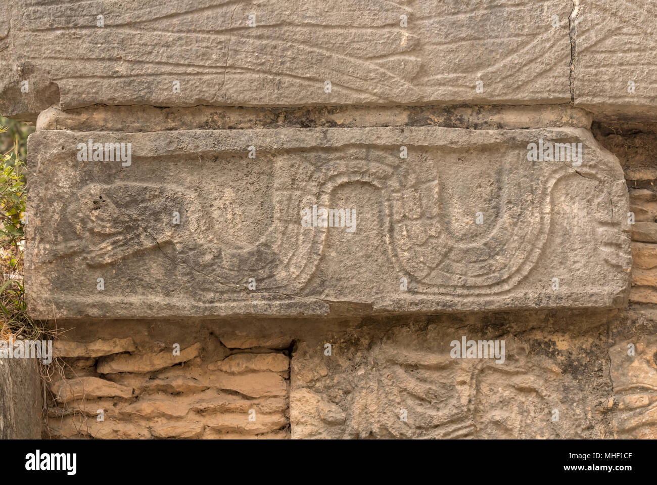Stone wall detail in Mayan ruins Chichen Itza. Bas relief carved Snake ...