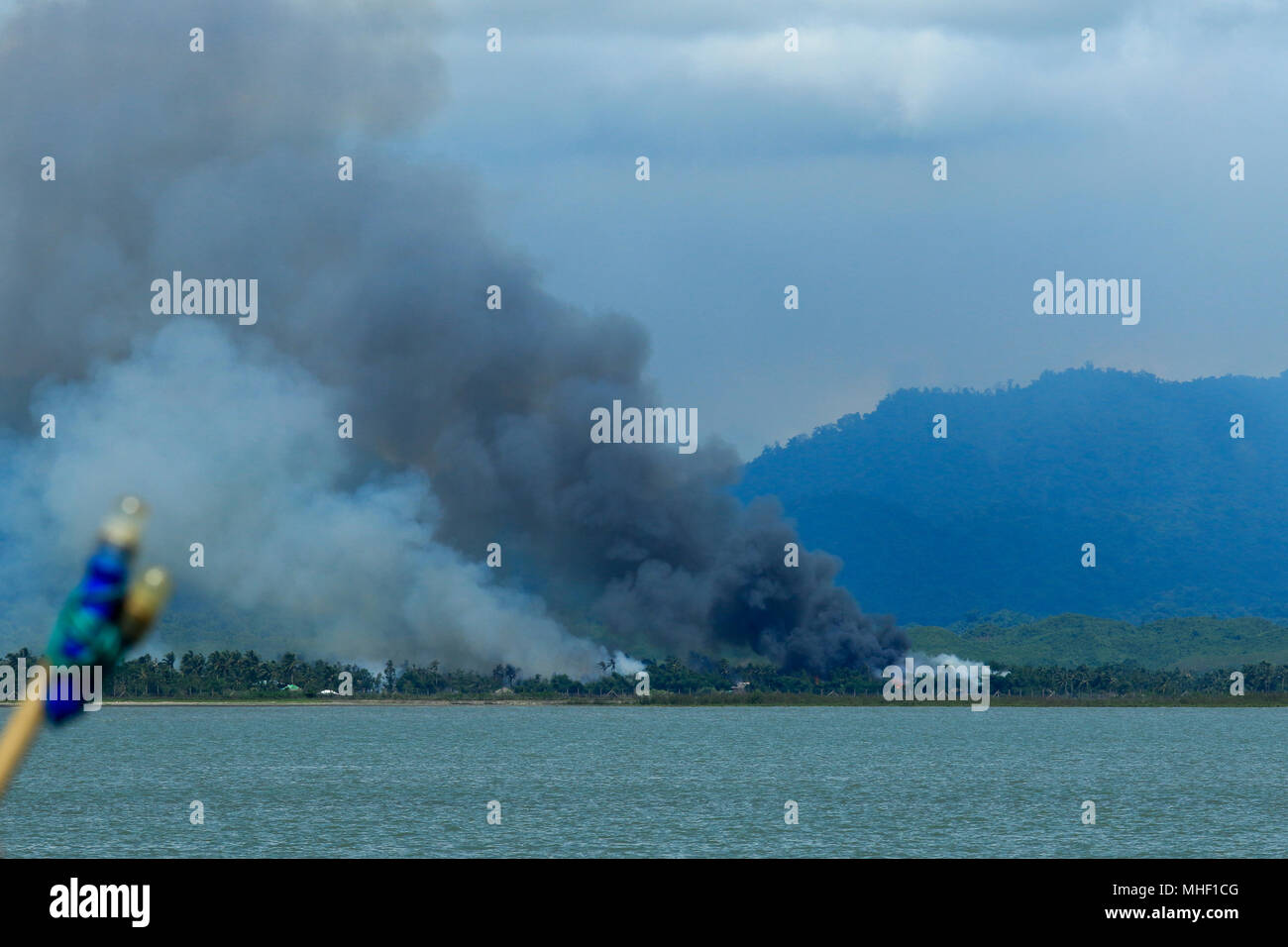 Smoke is seen on the villages in Maungdaw area in Myanmar border set on ...