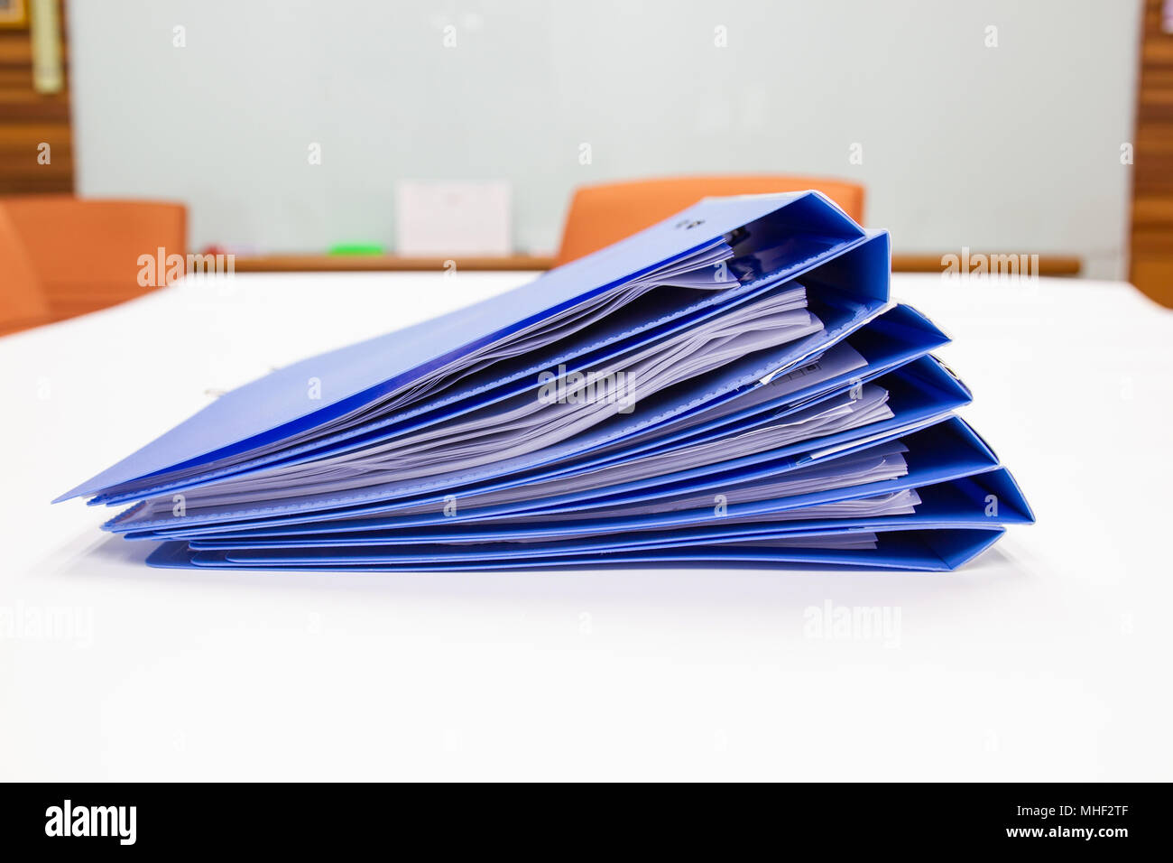 file folder with documents on table in office room Stock Photo - Alamy