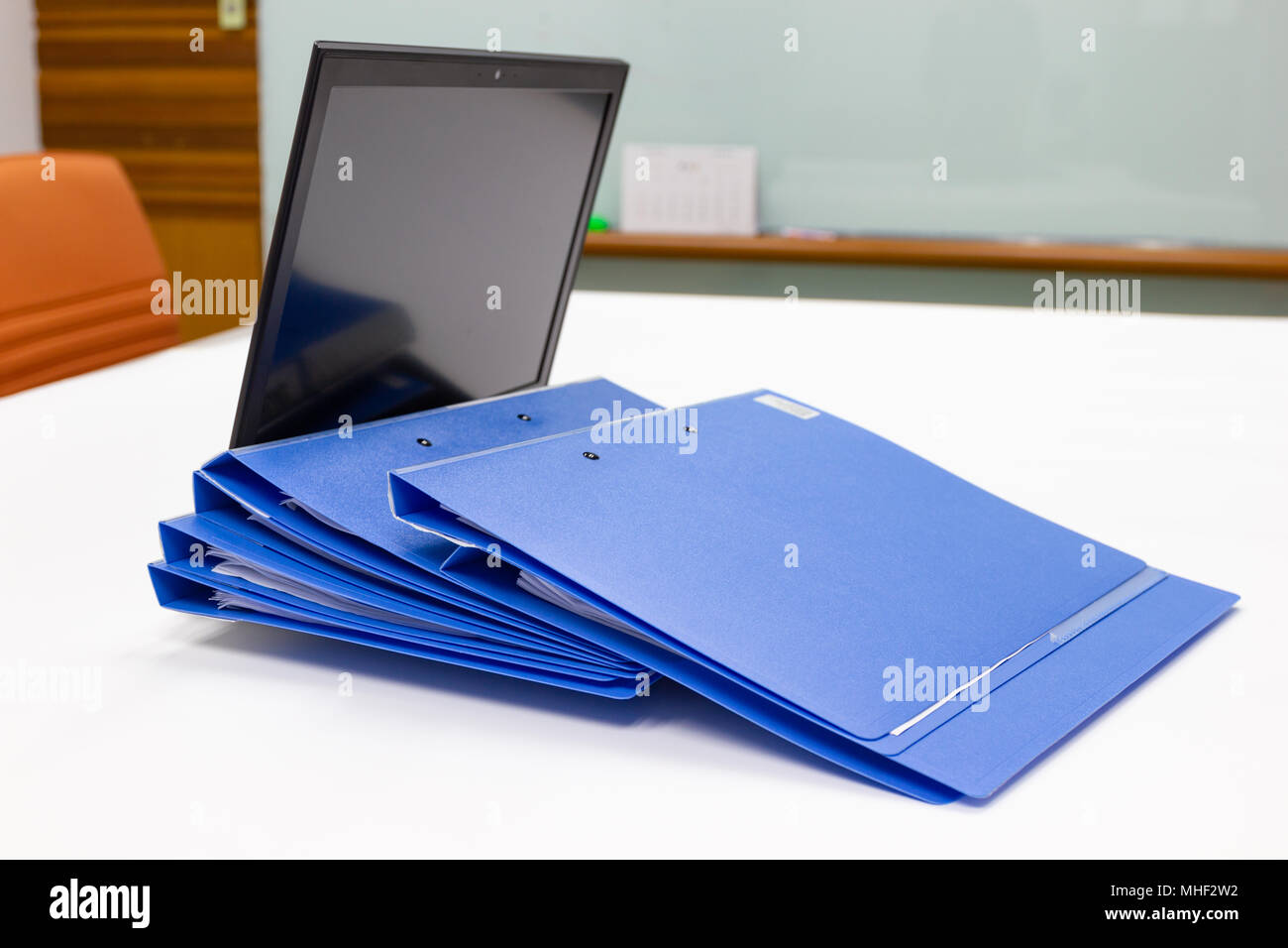 file folder with documents on table in office room Stock Photo - Alamy