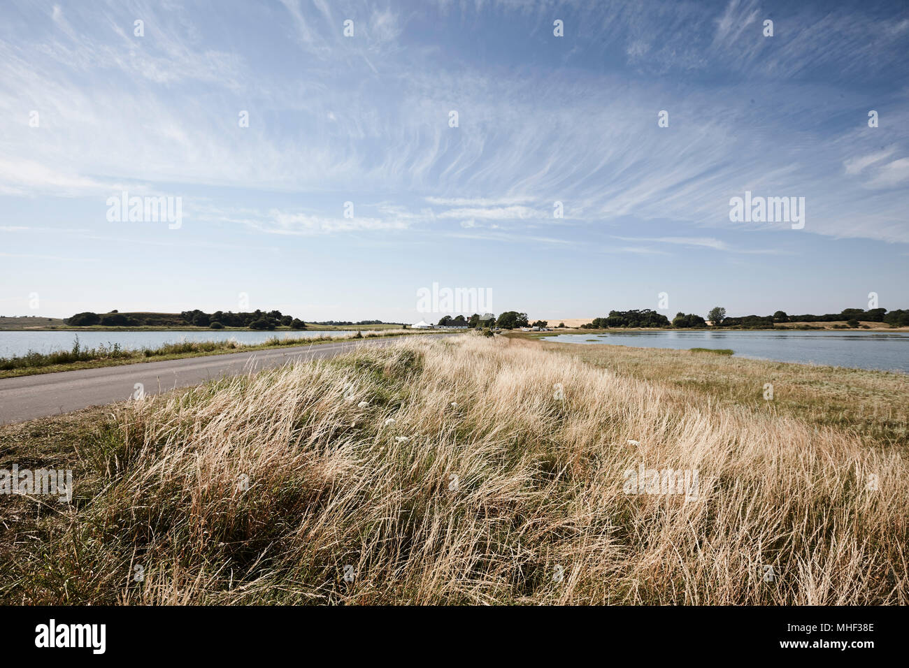 road with water of both sides and a blue sky Stock Photo - Alamy