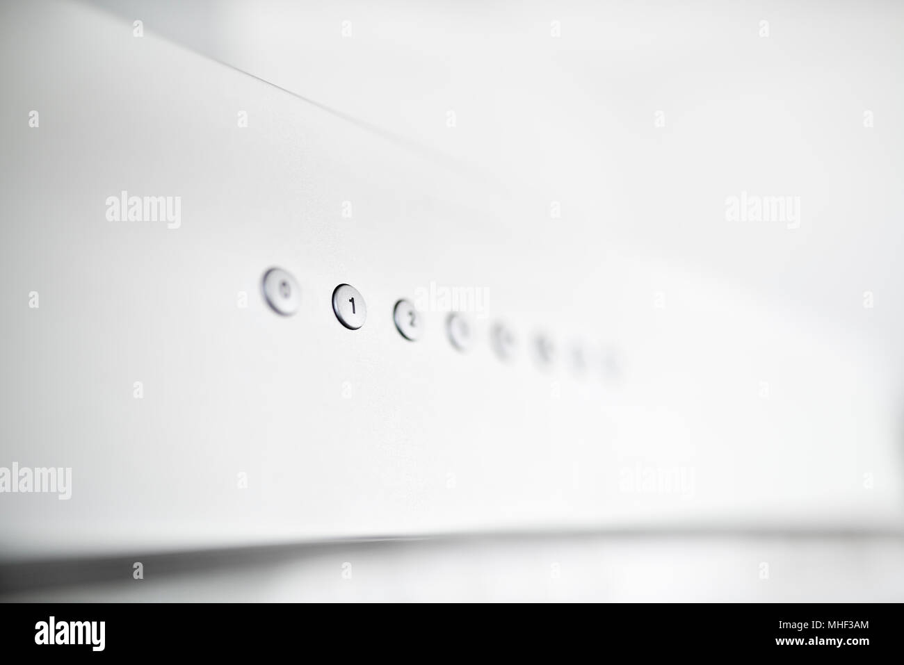 Buttons at a cooker hood of steel Stock Photo - Alamy