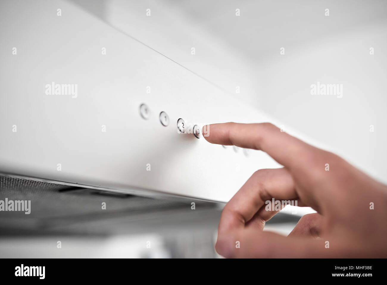 Buttons at a cooker hood of steel Stock Photo - Alamy
