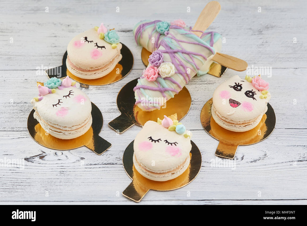 Cute macaroons with smiley faces on white wooden background Stock Photo ...