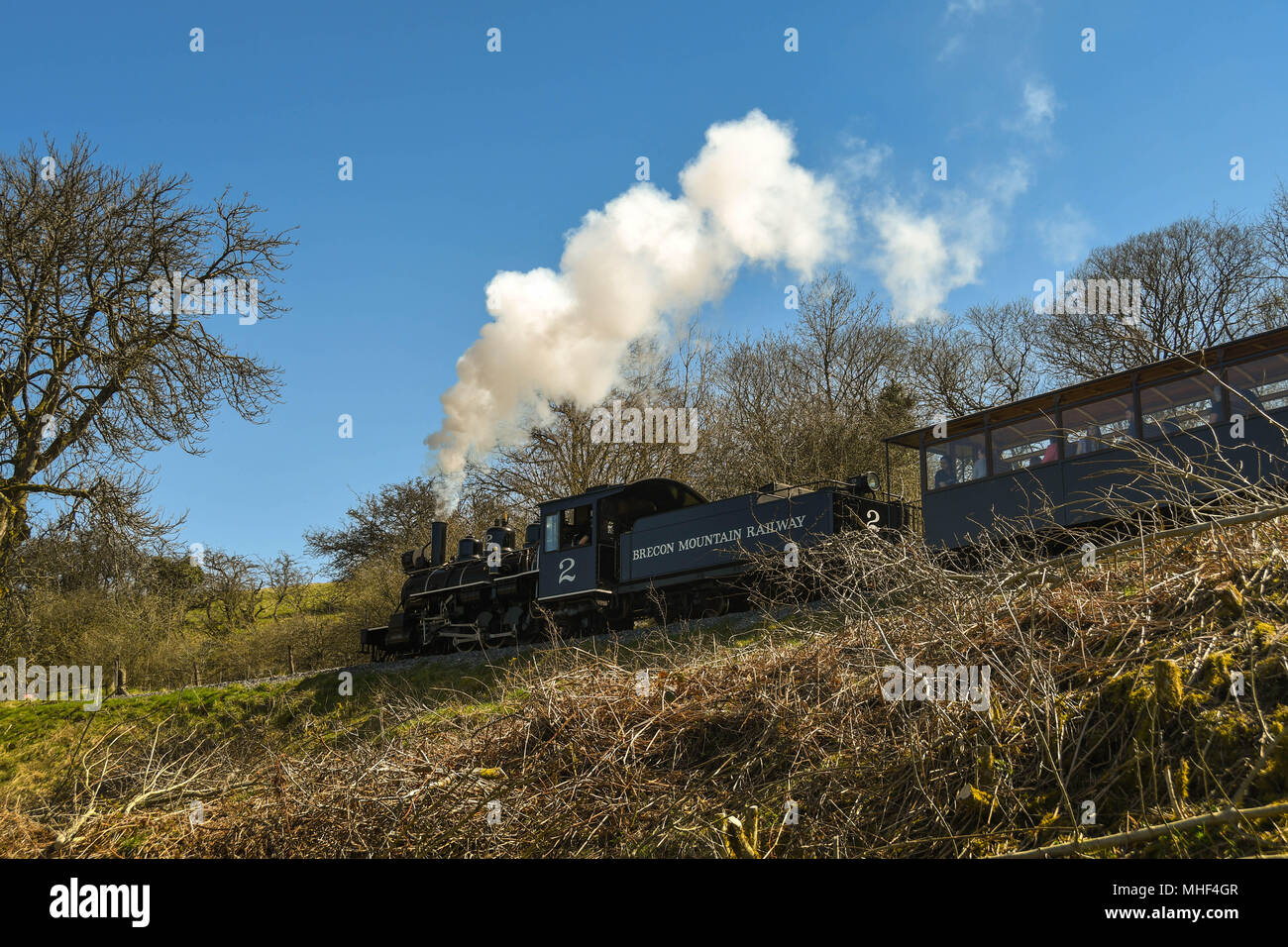 Steam engine pulling a train through countryside on the Brecon Mountain ...