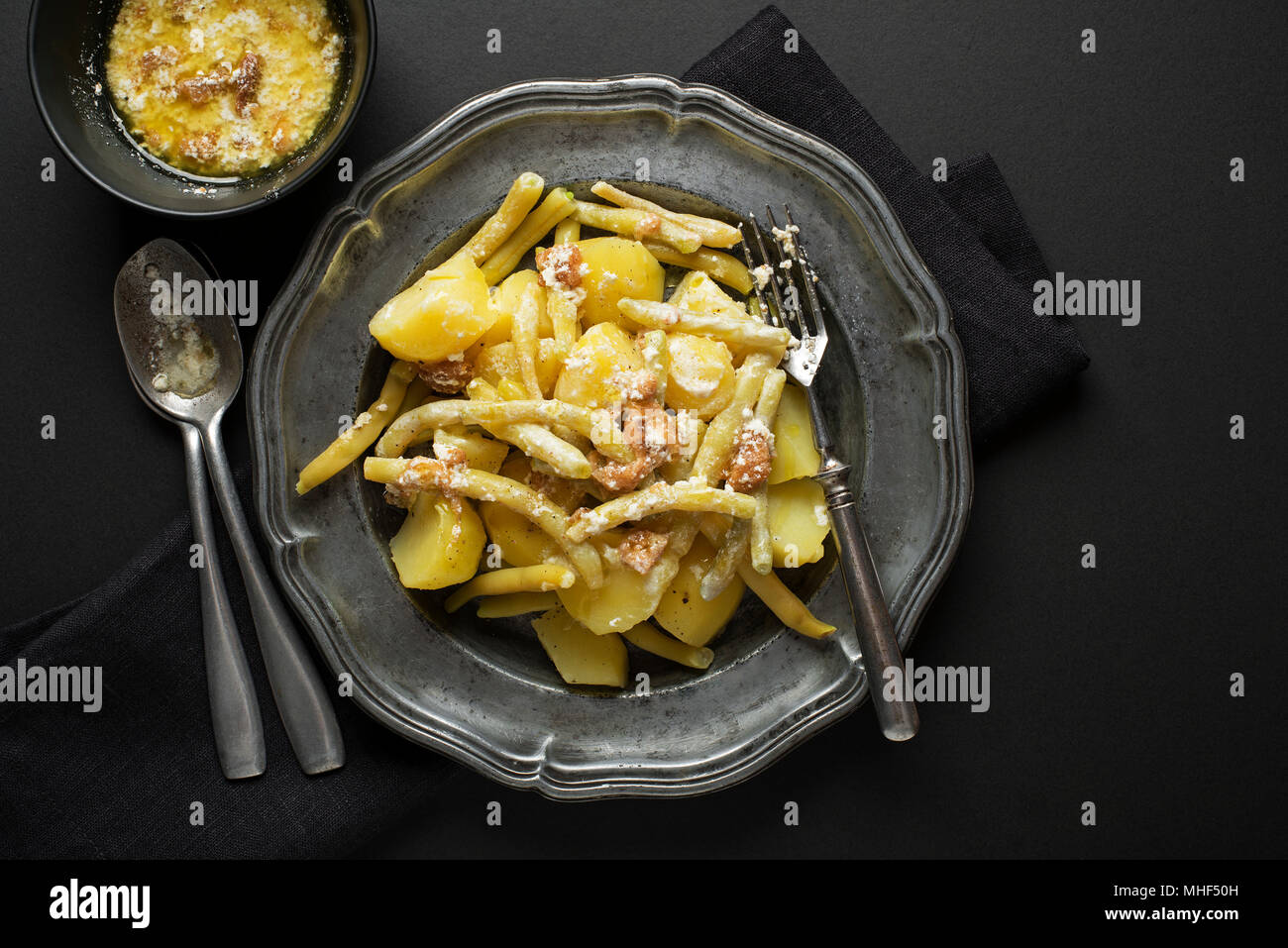 Traditional Slovenian meal with green beans and potatoes dressing with ...