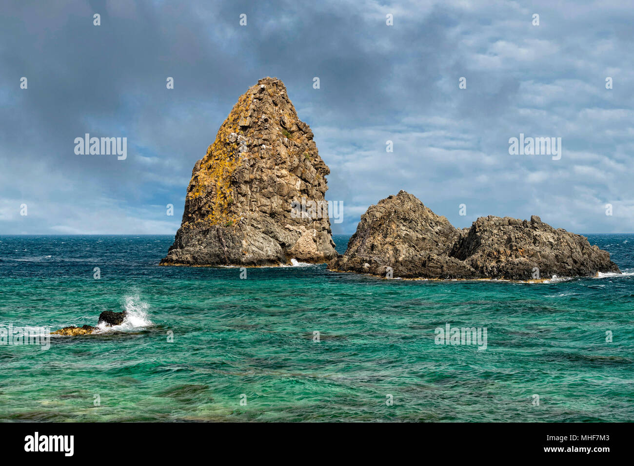 Aci Trezza Sicily Cyclopes Stacks on sunset sky background Stock Photo ...