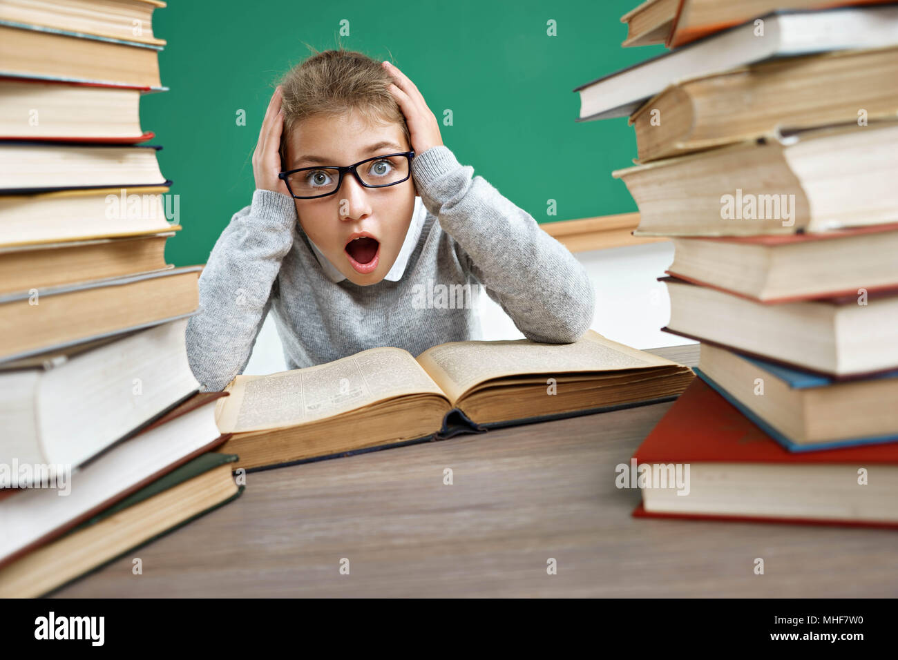 Student in shock. Photo of little schoolgirl with open mouth and big ...