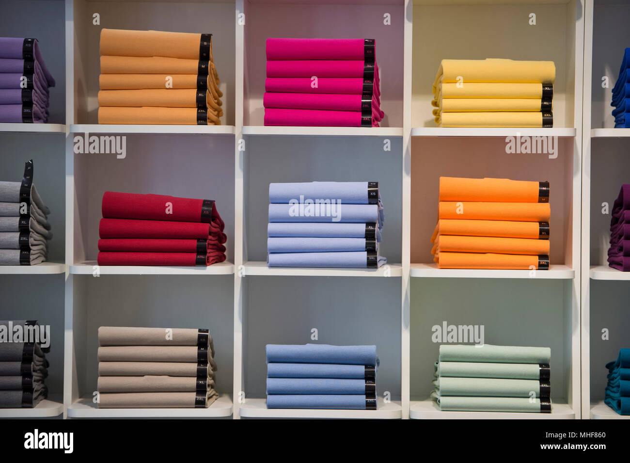 different colors polo shirt on display stand Stock Photo - Alamy